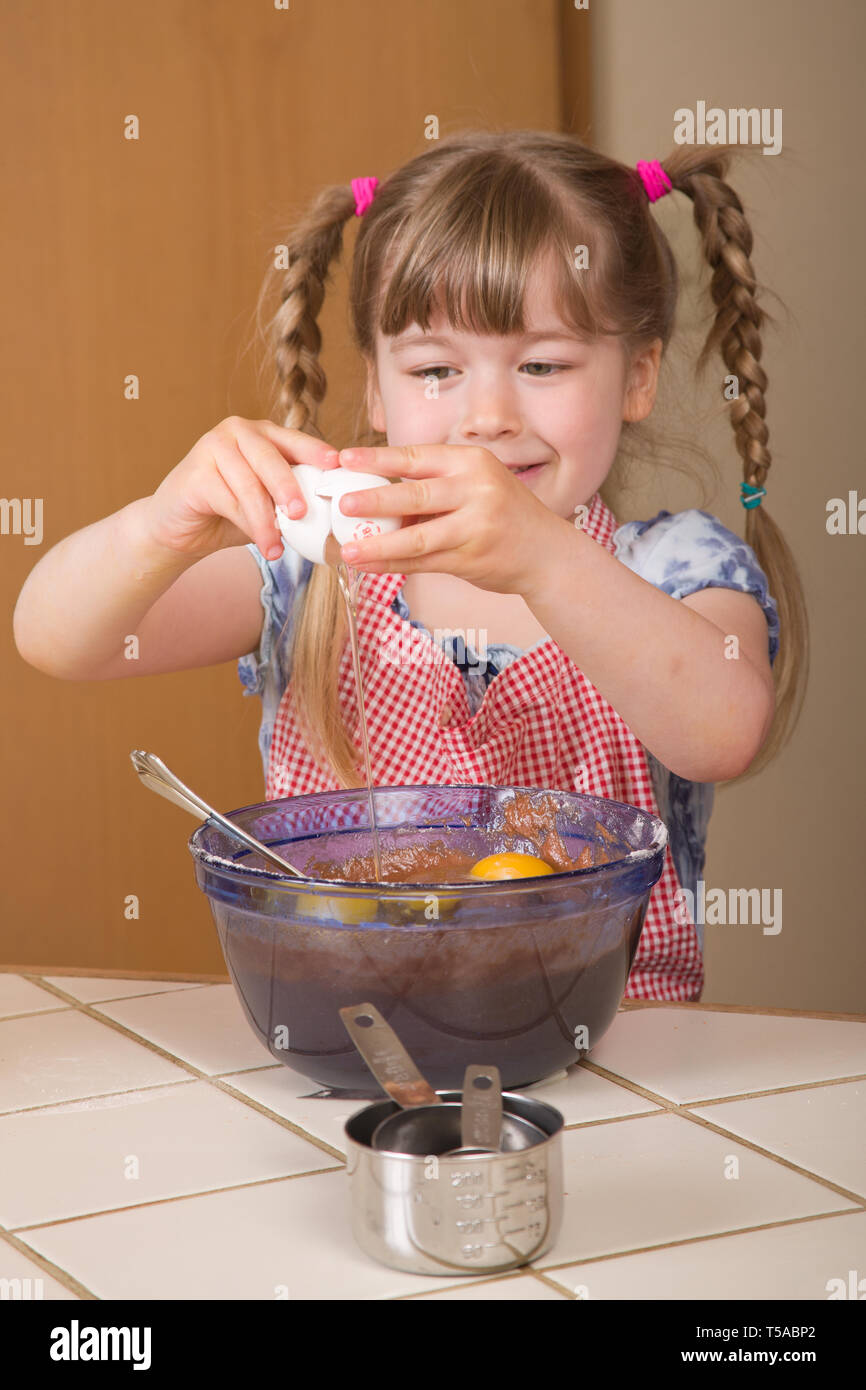 Child cracking egg hi-res stock photography and images - Alamy