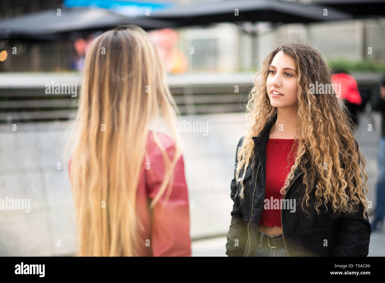 Female friends meeting in a city Stock Photo - Alamy