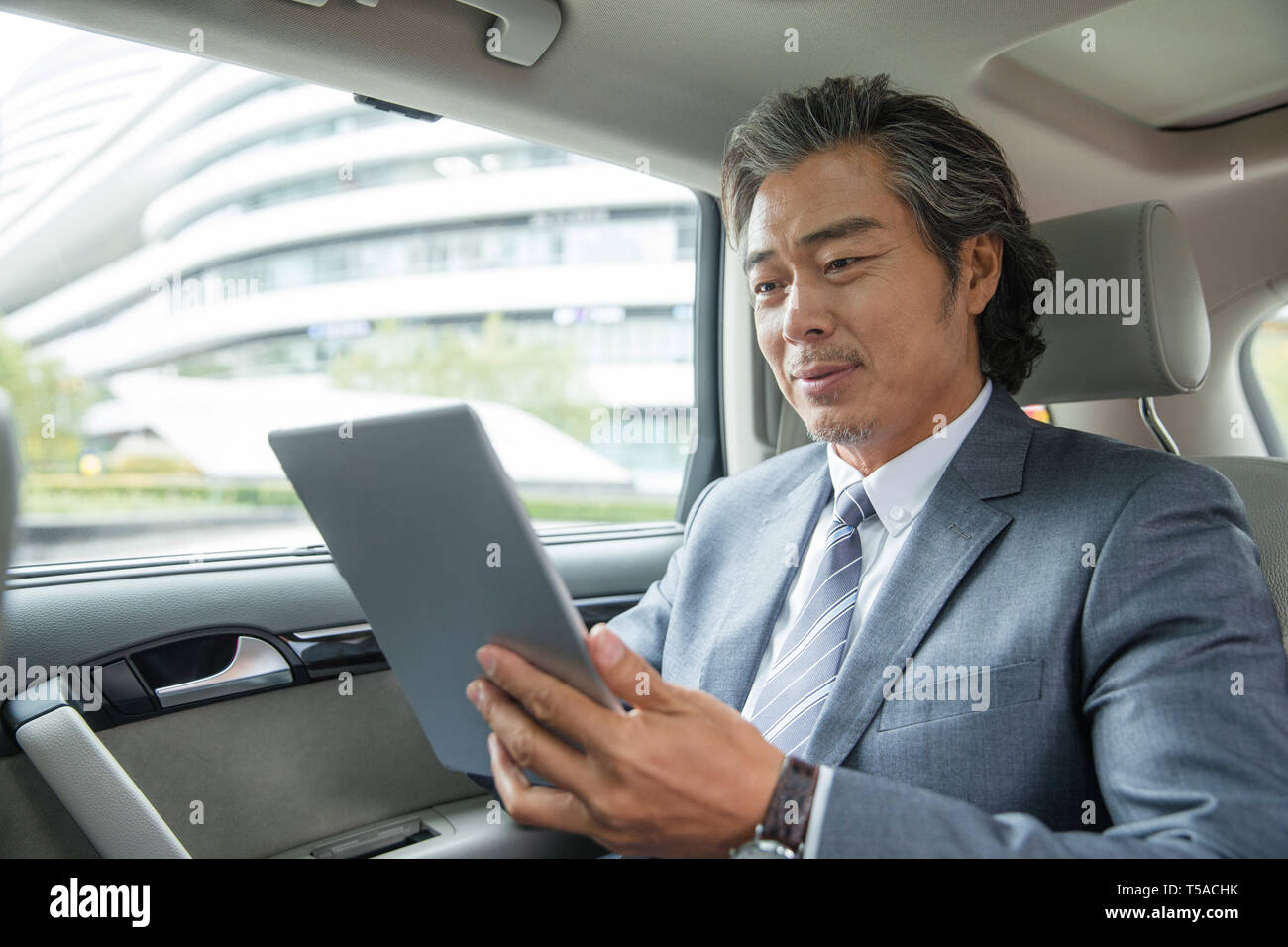 Business men see tablet in the car Stock Photo - Alamy