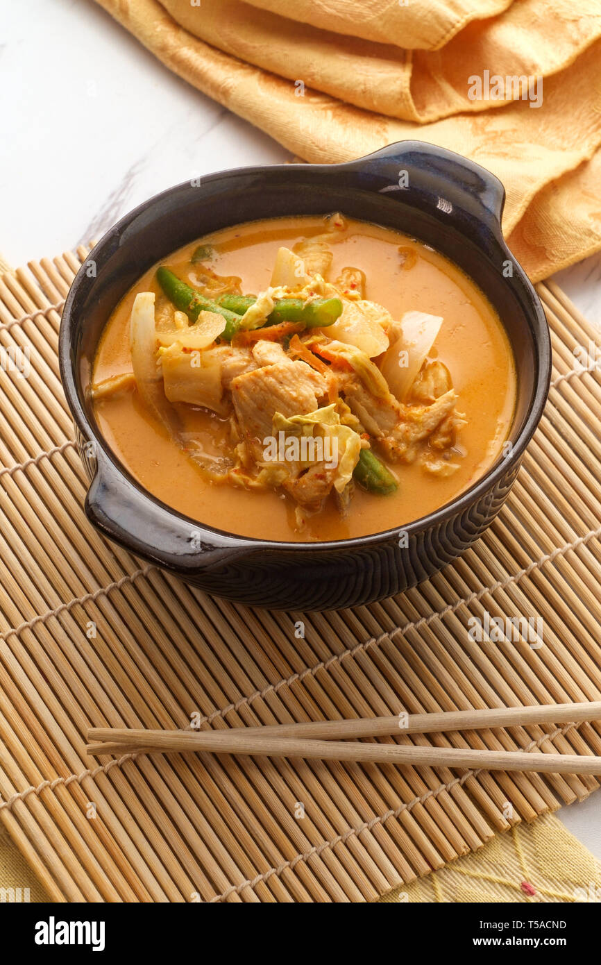 Thai food spicy coconut milk panang curry soup with chicken string ...