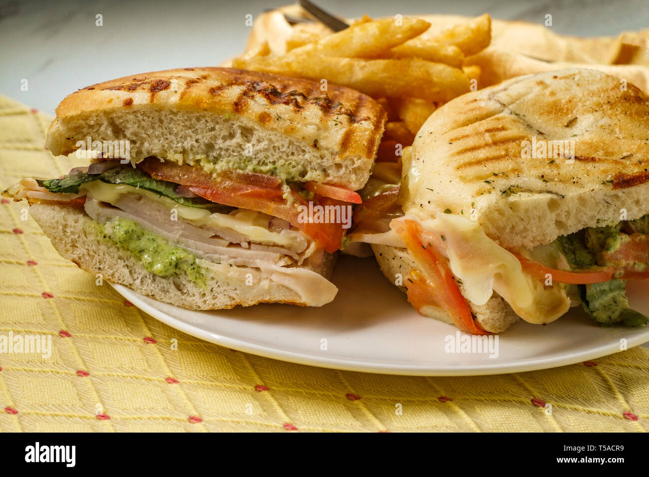 Smoked bistro turkey panini with provolone cheese pesto and tomatoes on ...