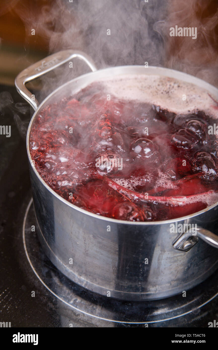 Beets cooking in boiling water in preparation for canning pickled beets ...