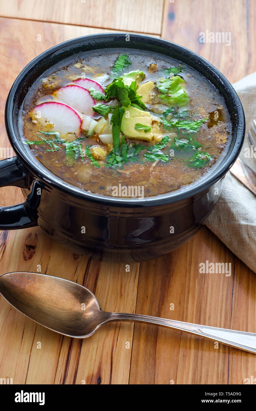 Authentic Mexican pozole soup with avocado cilantro and radish garnish ...