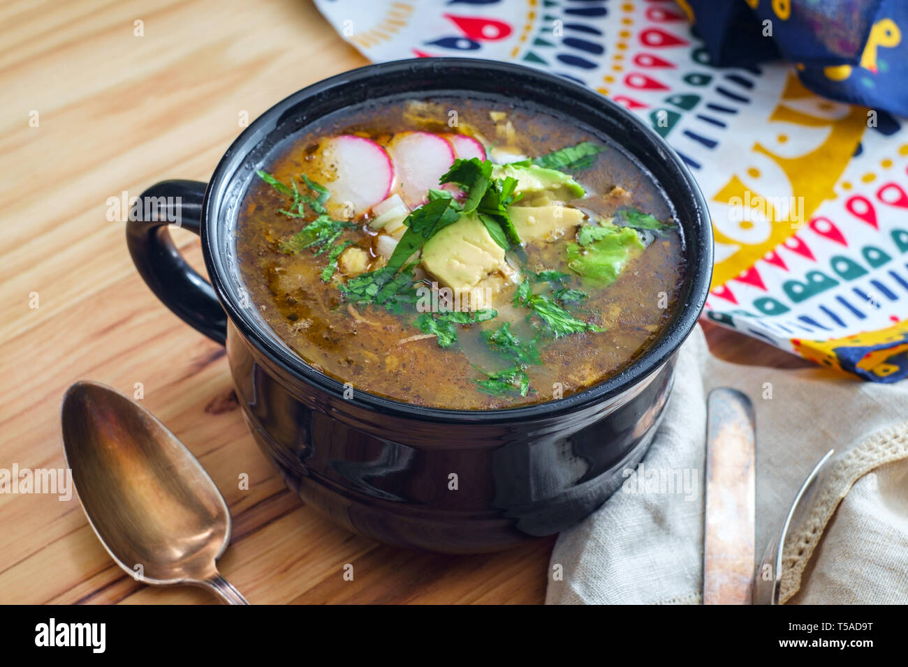 Authentic Mexican pozole soup with avocado cilantro and radish garnish ...