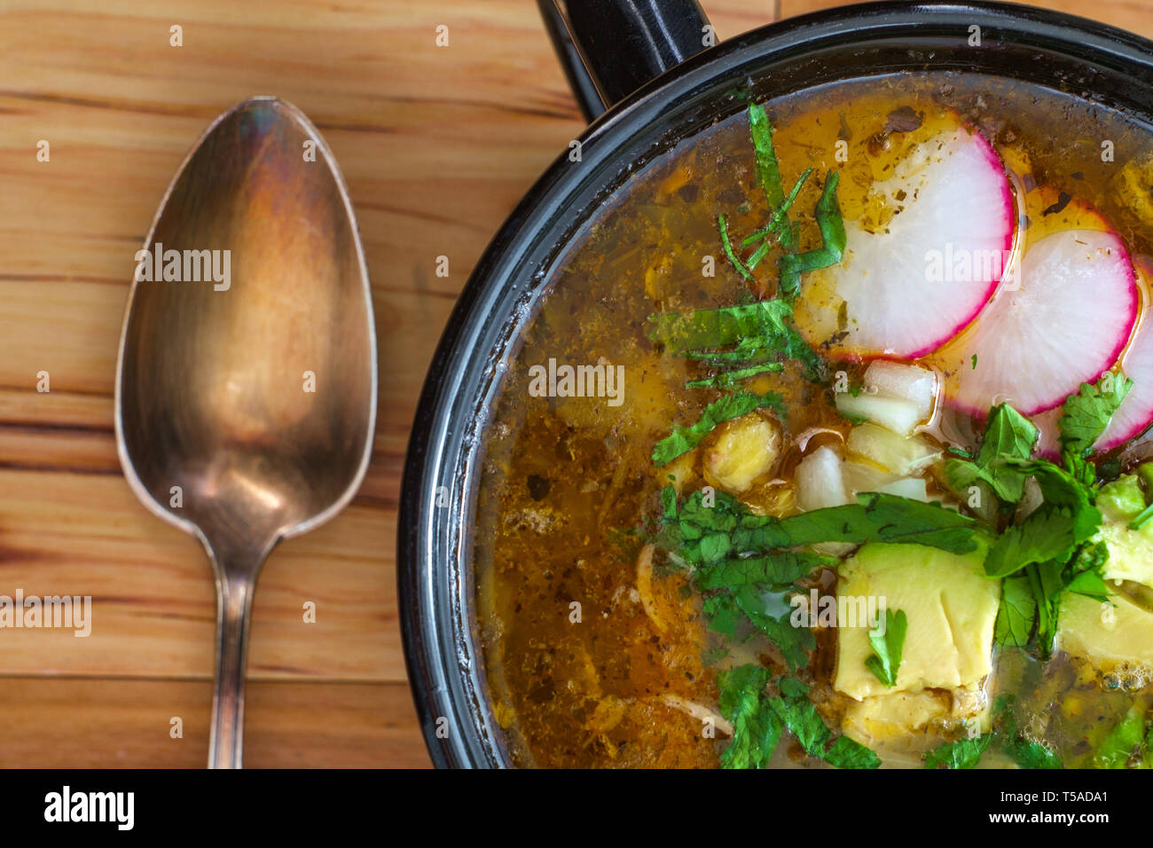 Authentic Mexican pozole soup with avocado cilantro and radish garnish ...
