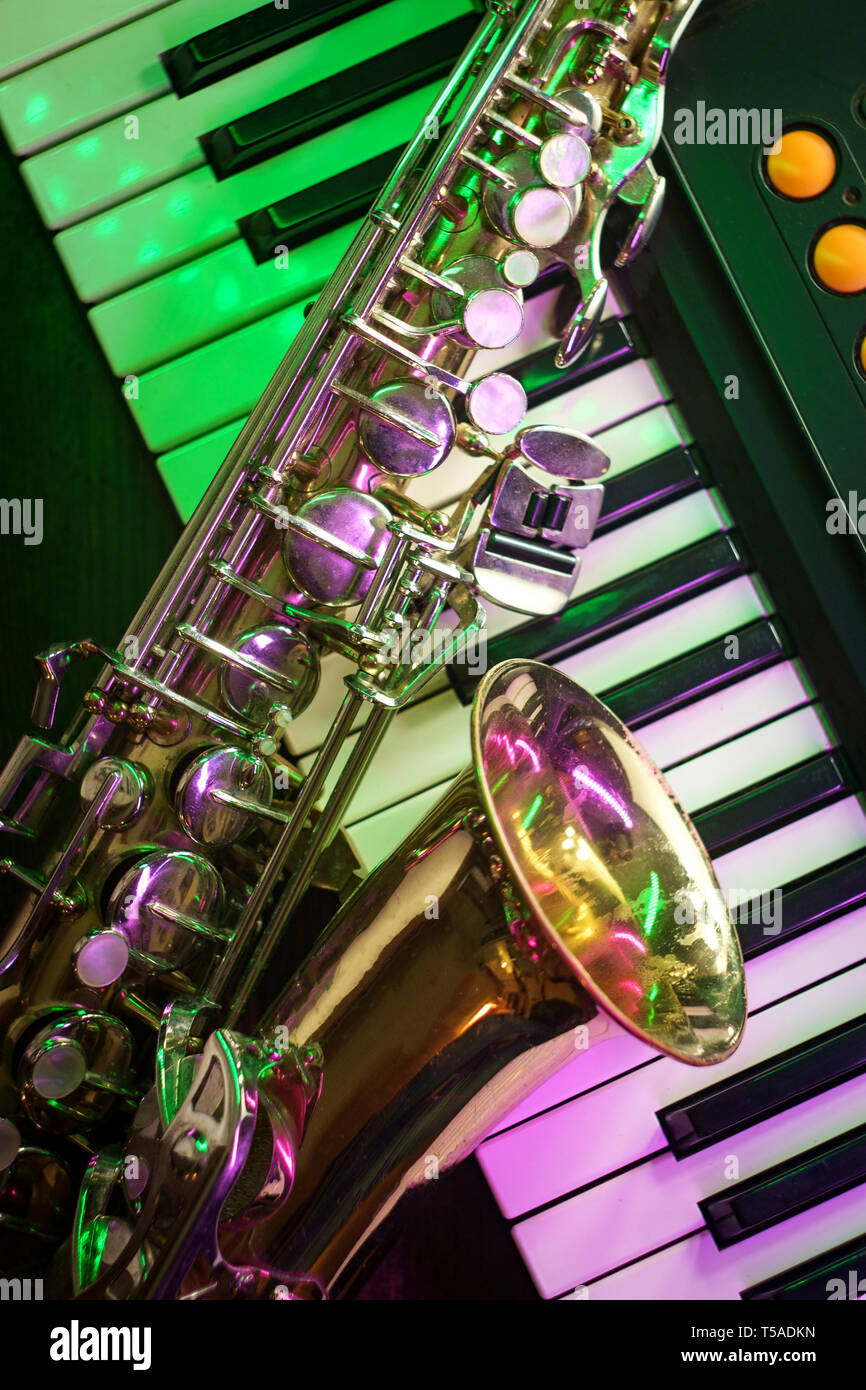 Old and worn Jazz saxophone and piano keyboard musical show and ...