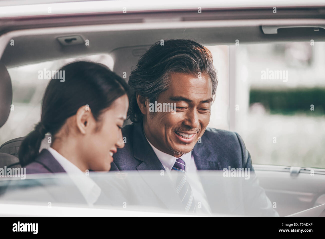 Business people in the car to talk Stock Photo - Alamy