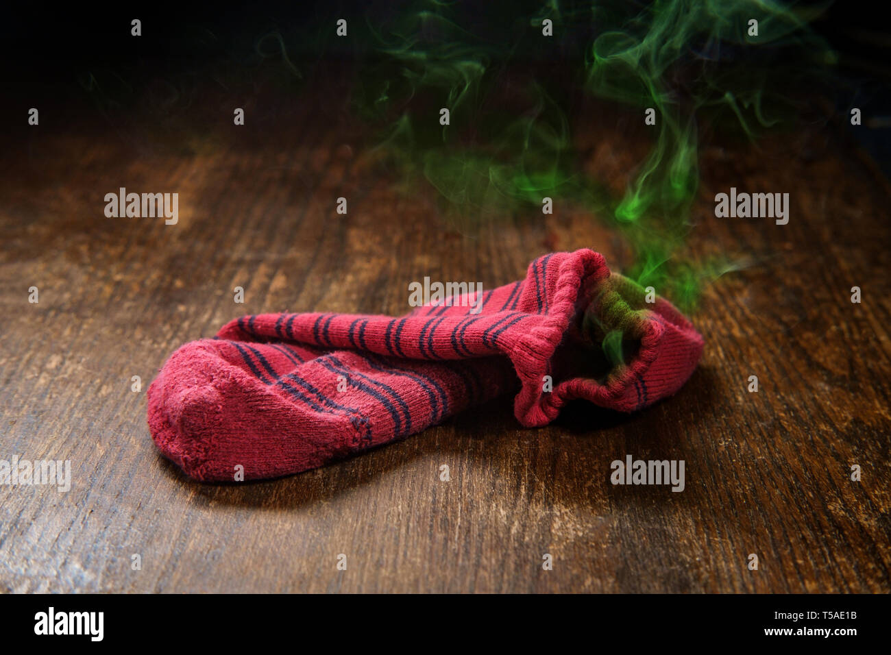 Smelly dirty laundry sock with colorful visible odor vapor Stock Photo ...