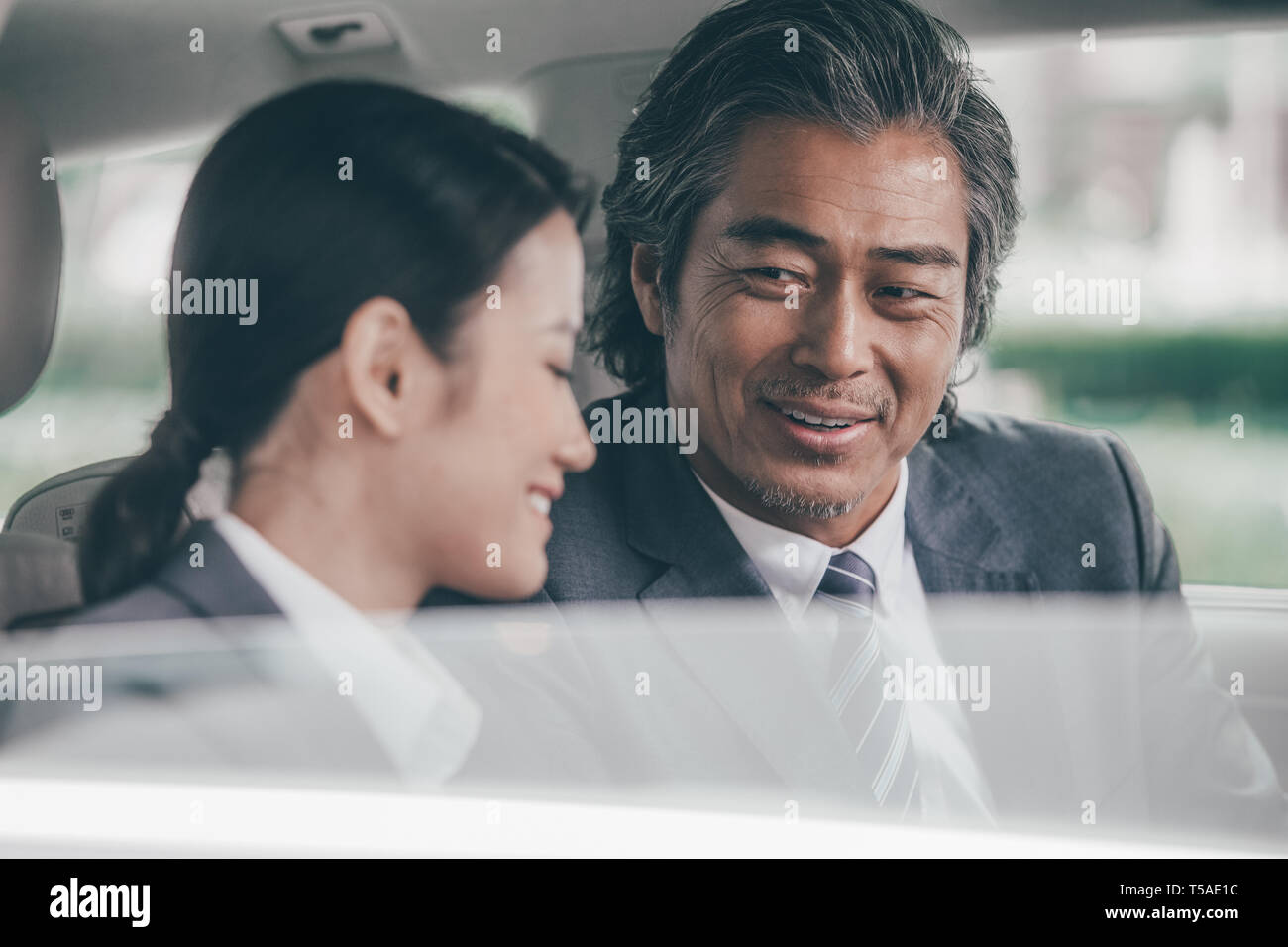 Business people in the car to talk Stock Photo - Alamy