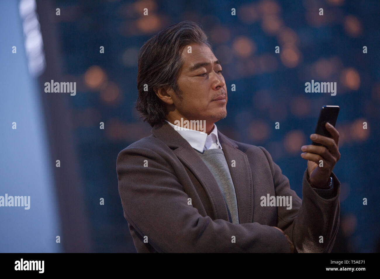 Business men see a mobile phone Stock Photo - Alamy