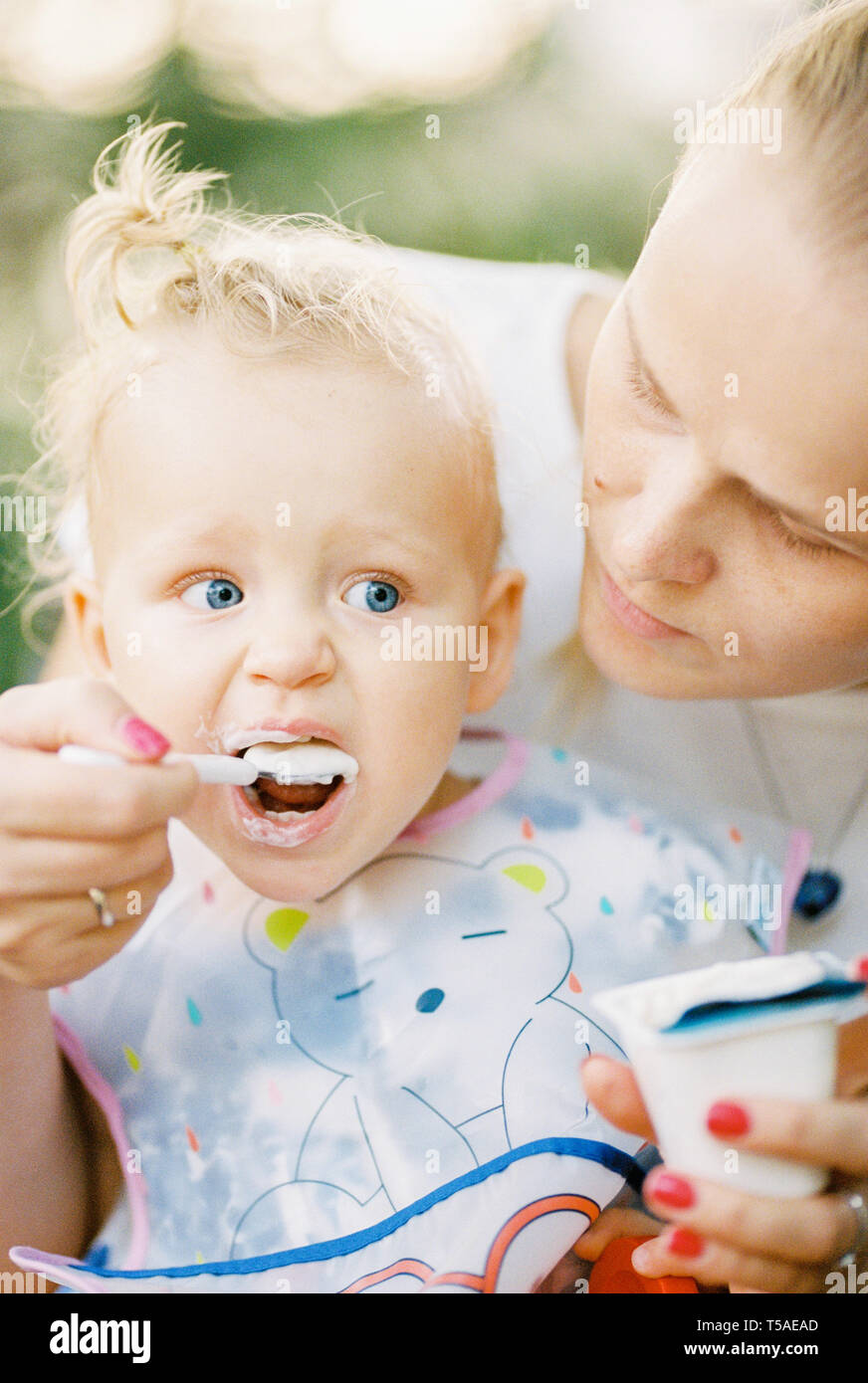 Feeding a baby girl Stock Photo - Alamy