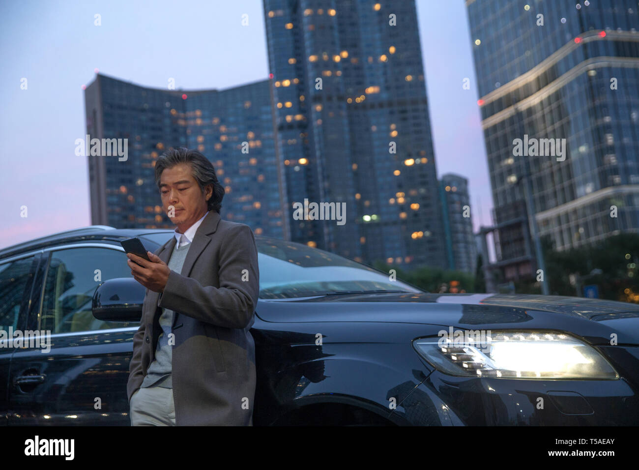 Business men see a mobile phone Stock Photo - Alamy