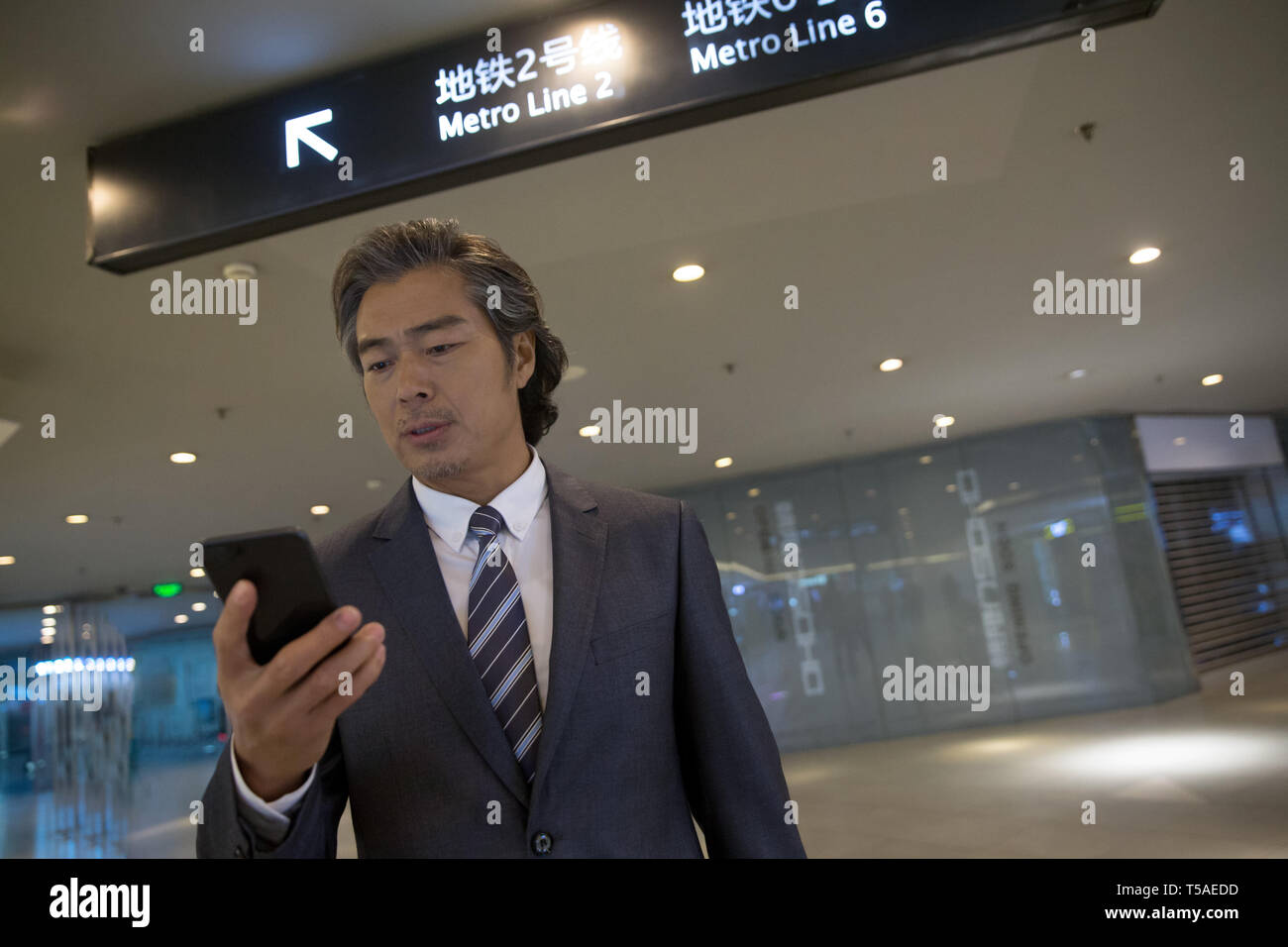 Business men see a mobile phone Stock Photo - Alamy