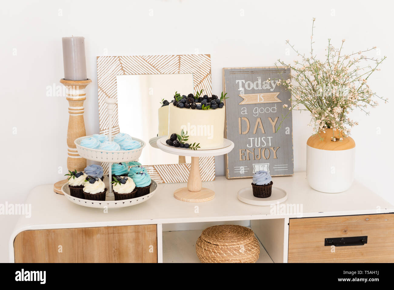 Rustic, boho candy bar. Table with cake, cupcakes and different sweets ...