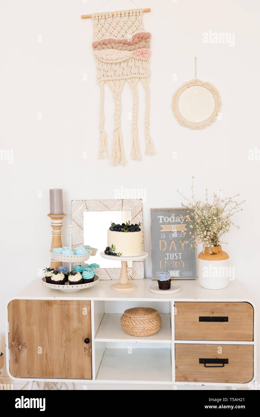 Rustic, boho candy bar. Table with cake, cupcakes and different sweets ...