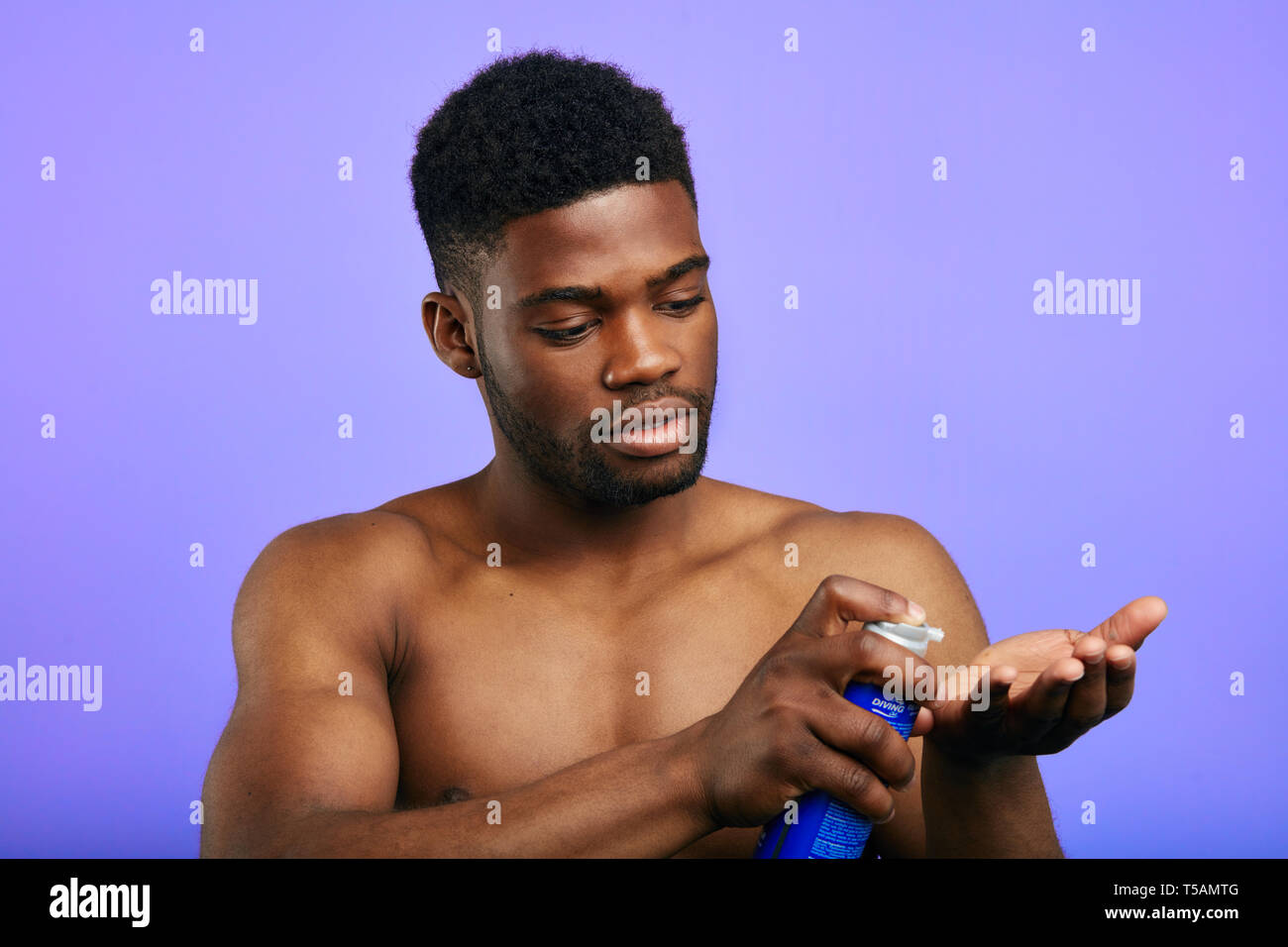 handsome young brutal man putting shaving foam on the palm, preparation ...