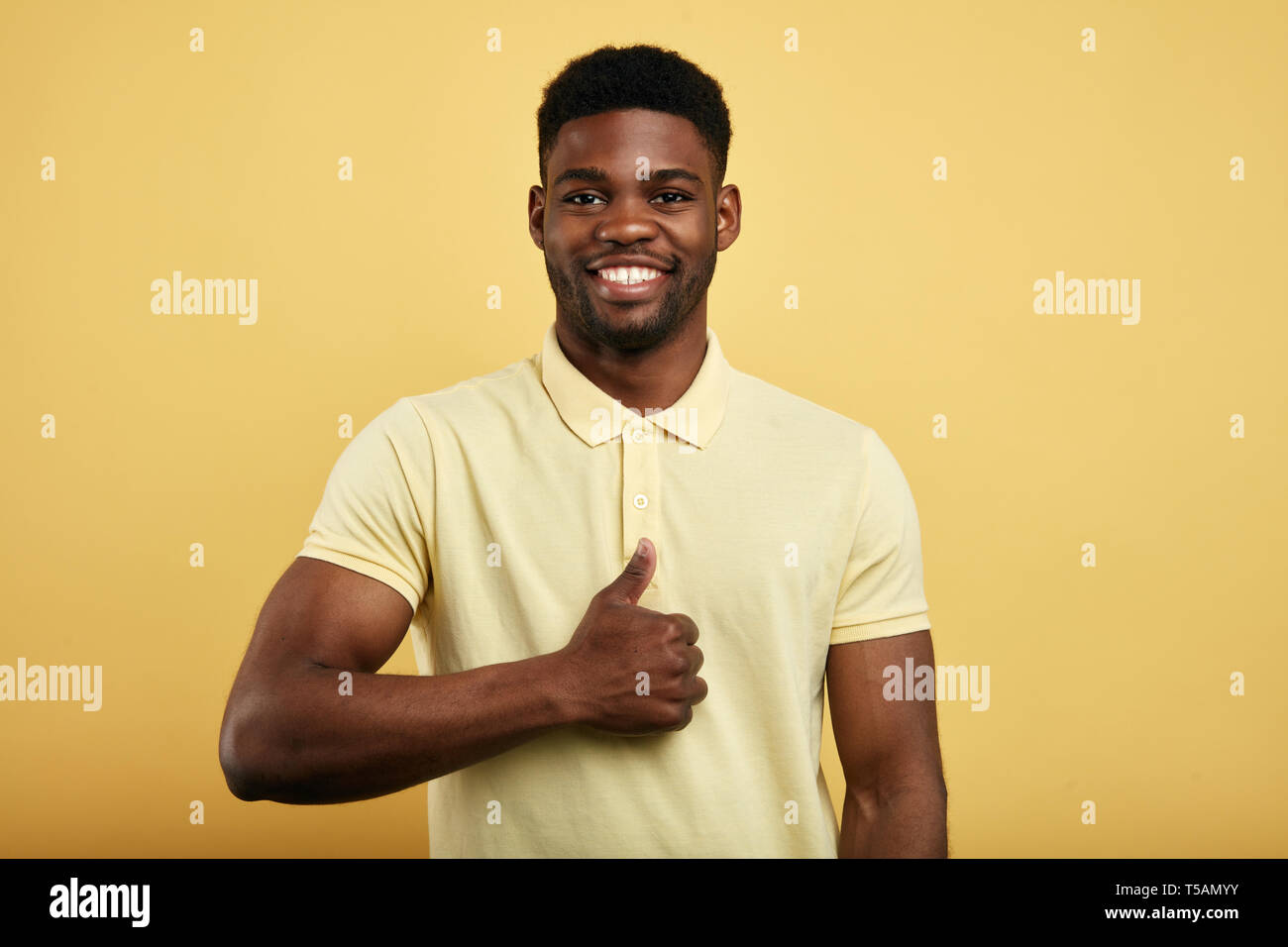 Happy successful guy showing thumb up, cheering somebody up, expresses ...