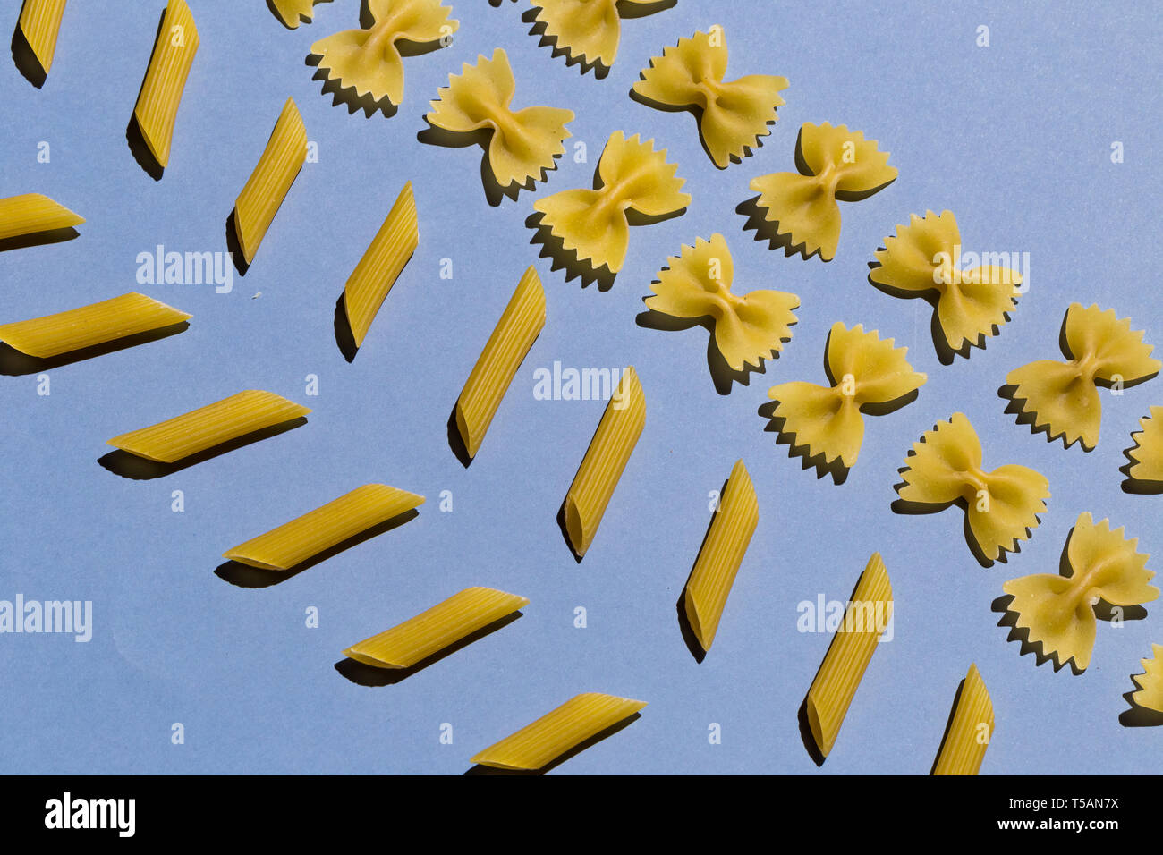 two kinds of macaroni on the blue table, design concept. creativity ...