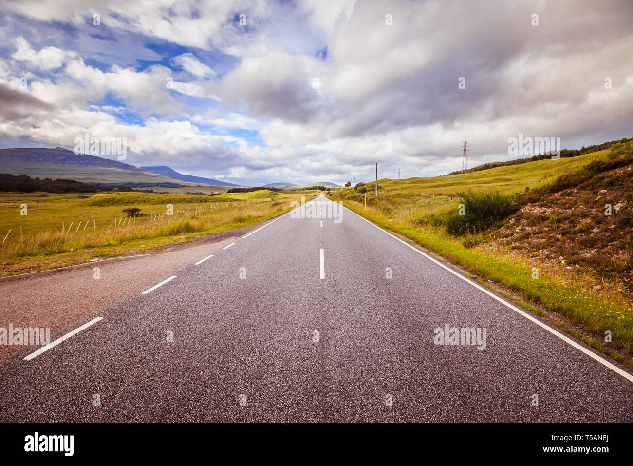 Asphalted, dramatic road in Scotland. Nobody and cloudy sky Stock Photo ...