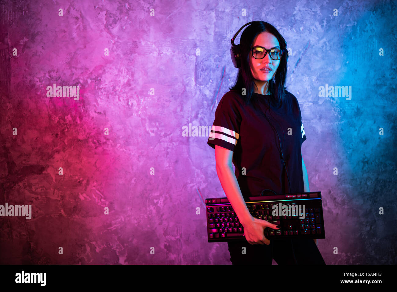 Gamer girl playing with computer at home. Young female posing with ...