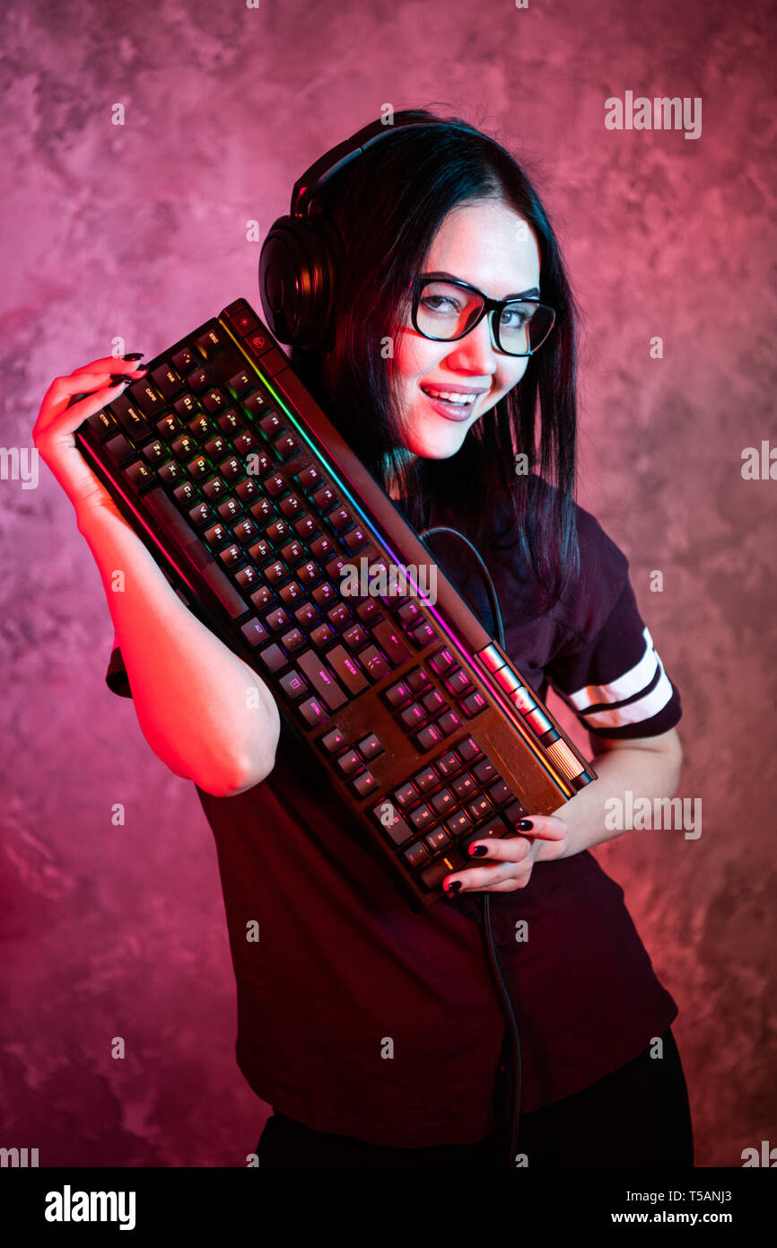 Gamer girl playing with computer at home. Young female posing with ...