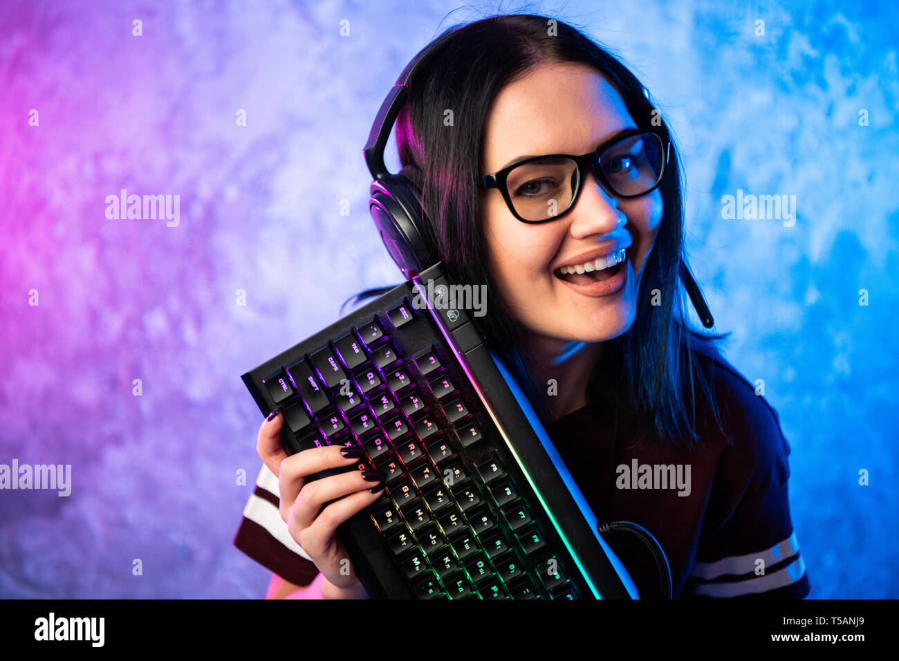 Gamer girl playing with computer at home. Young female posing with ...