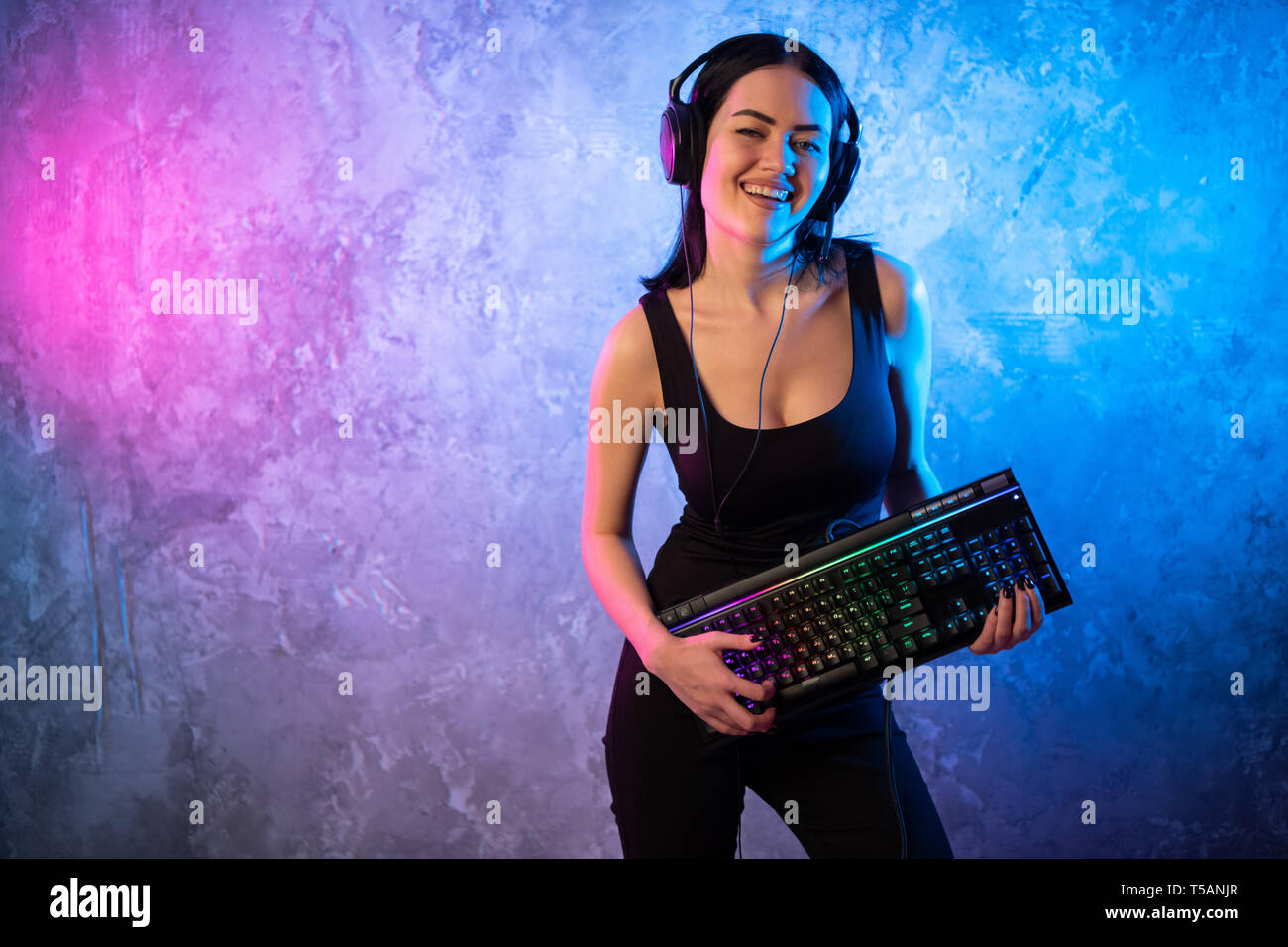 Funny nerd gamer girl posing with gaming keyboard, playing computer ...
