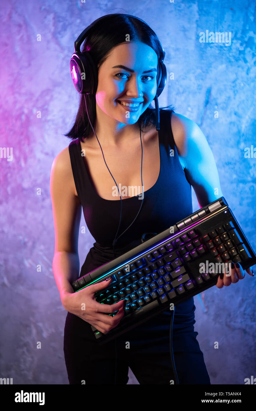 Gamer girl playing with computer at home. Young female posing with ...