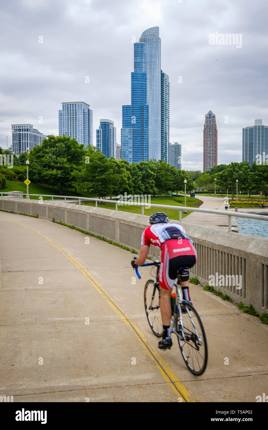 Biker riding with Downtown Chicago in the background Stock Photo - Alamy