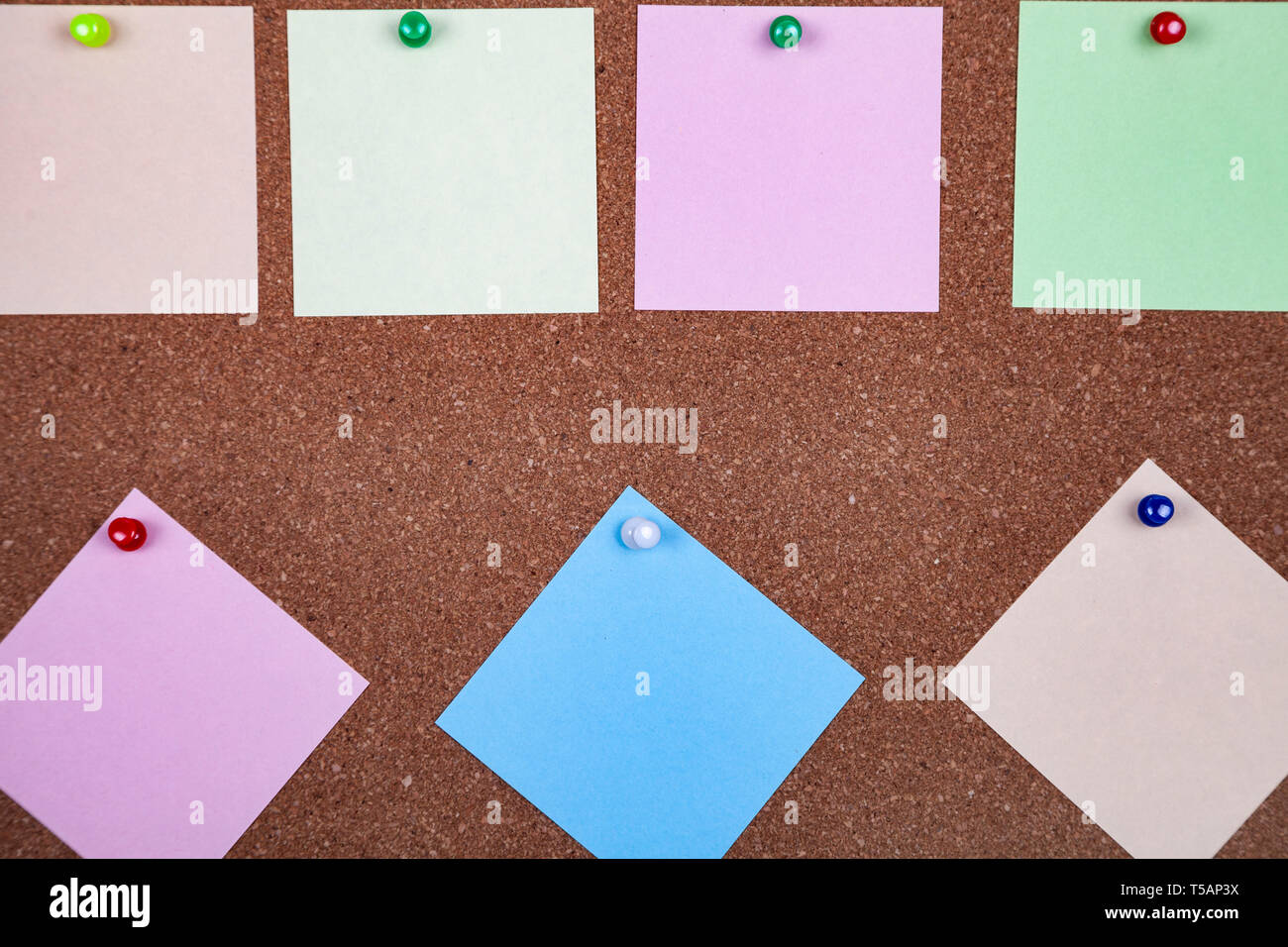 Corkboard with notes. Colored paper on corkboard Stock Photo - Alamy