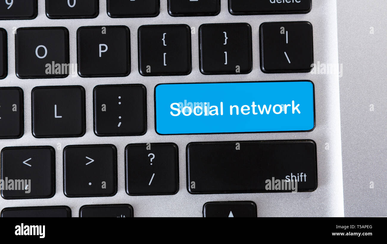 Social network blue button on computer keypad Stock Photo - Alamy