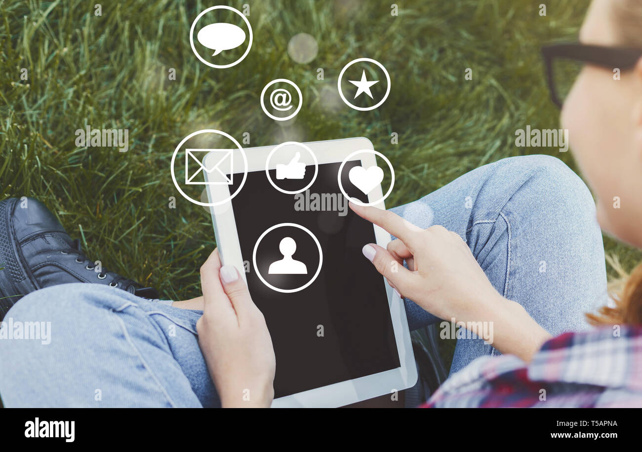 Woman touching tablet screen with virtual icons Stock Photo - Alamy