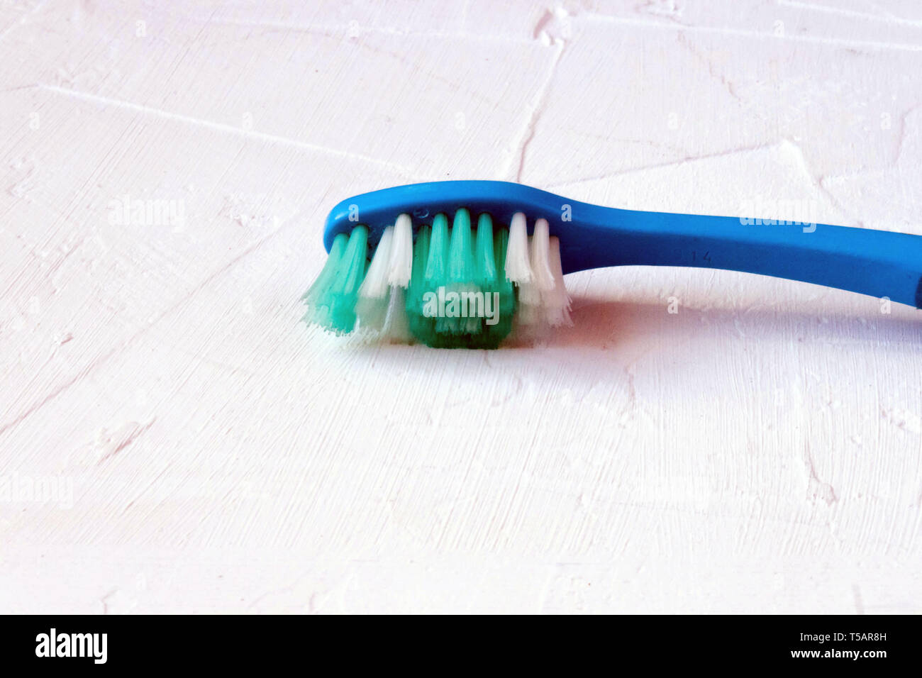Used worn blue toothbrush close up isolated on white background ...