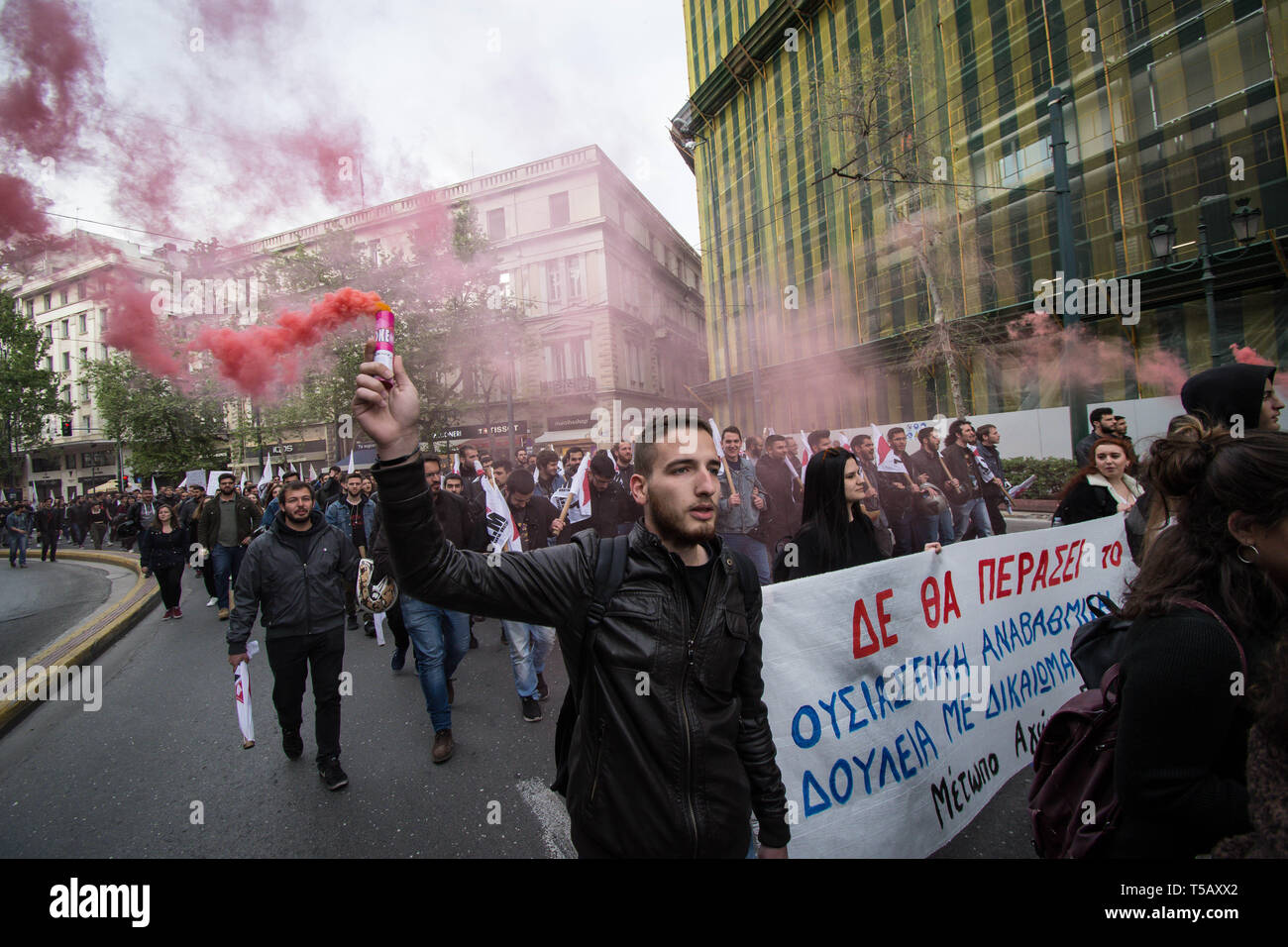 A protester seen holding a red smoke flare during the demonstration ...