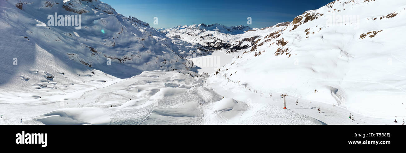 Beautiful winter landscape with Swiss Alps. Skiers skiing in famous ...