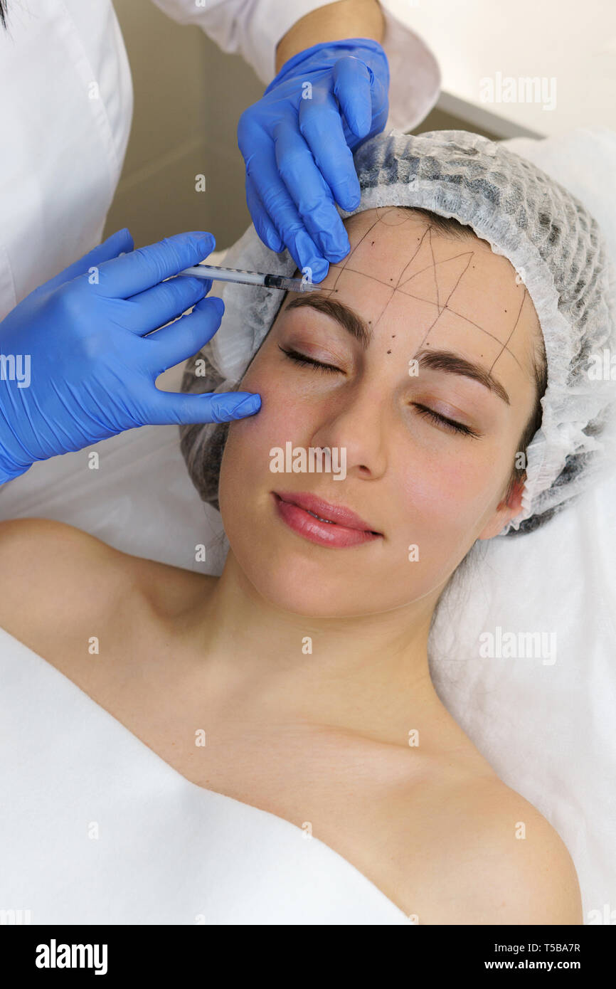 Aesthetic cosmetology. Hands cosmetologist injections of hyaluronic ...