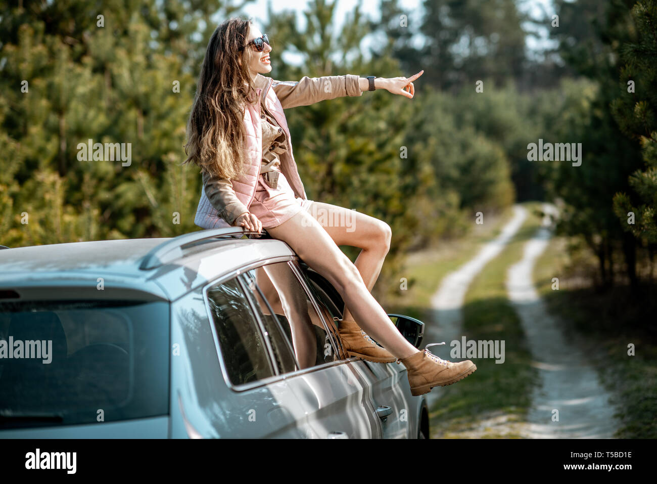 Girl on car roof hi-res stock photography and images - Alamy