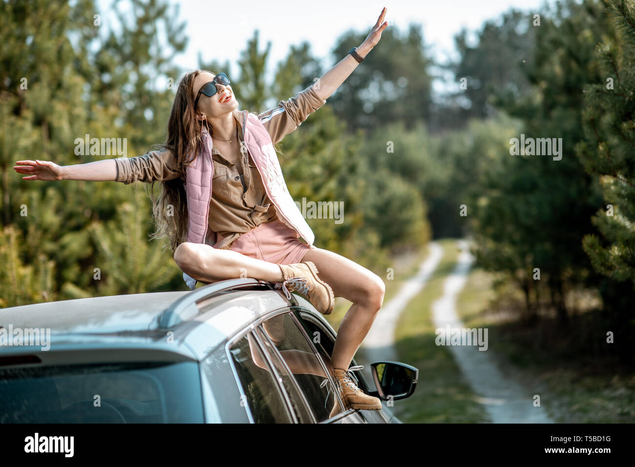 Girl on car roof hi-res stock photography and images - Alamy