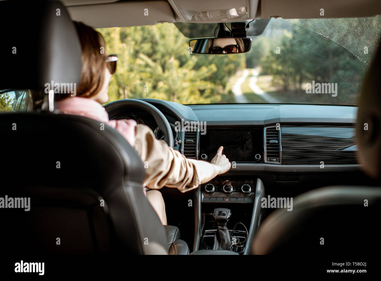 Woman driving car on the forest road, view from the car interior Stock ...