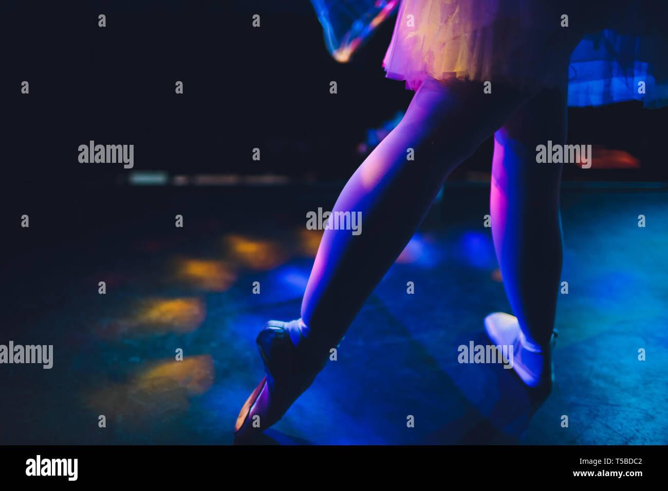 Ballerina legs in pointes on parquet floor on dark background Stock ...