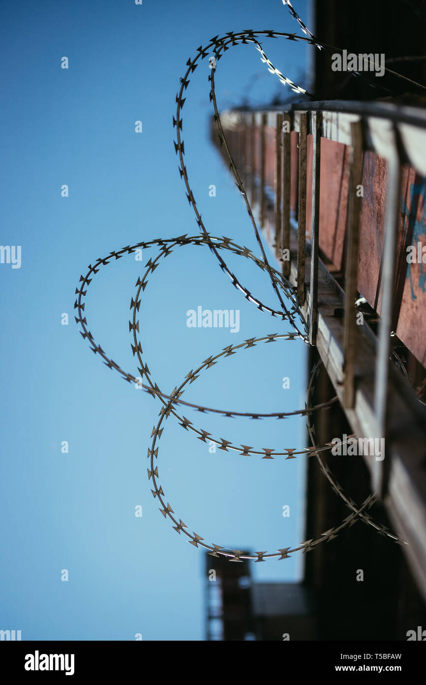 Close up perspective of barbed wire in the prison or on a military base ...