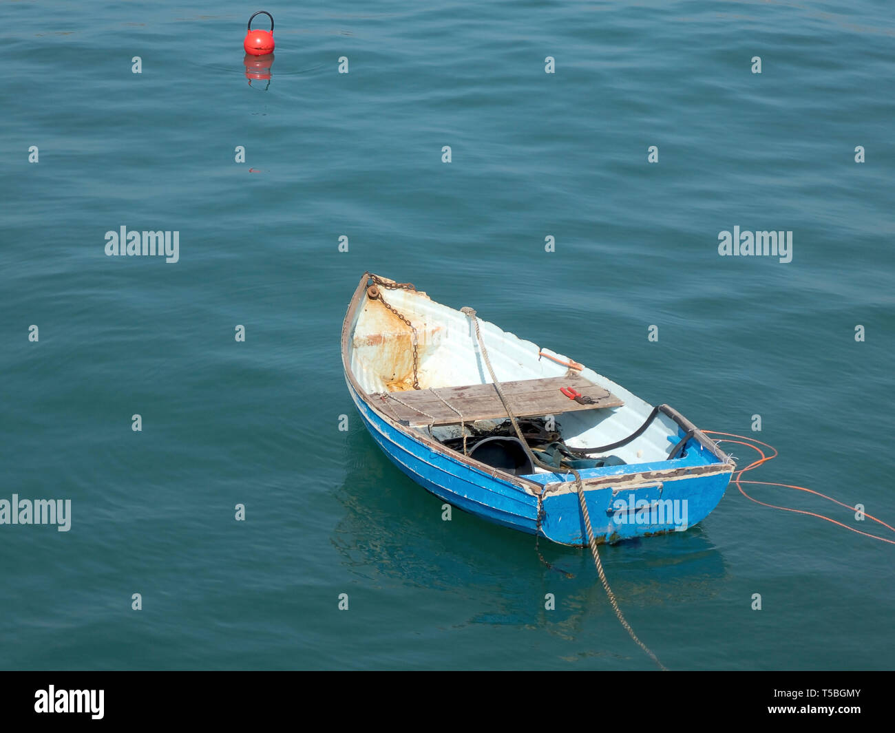 Row boat at anchor in harbour Stock Photo - Alamy