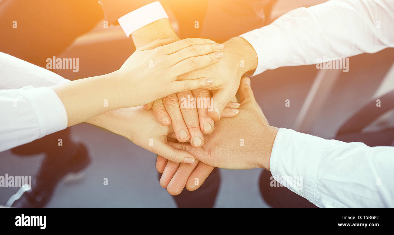 Male and female office workers, colleagues, teams folded in one pile ...