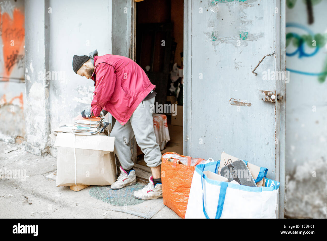 Homeless person collecting waste to recycle hi-res stock photography ...