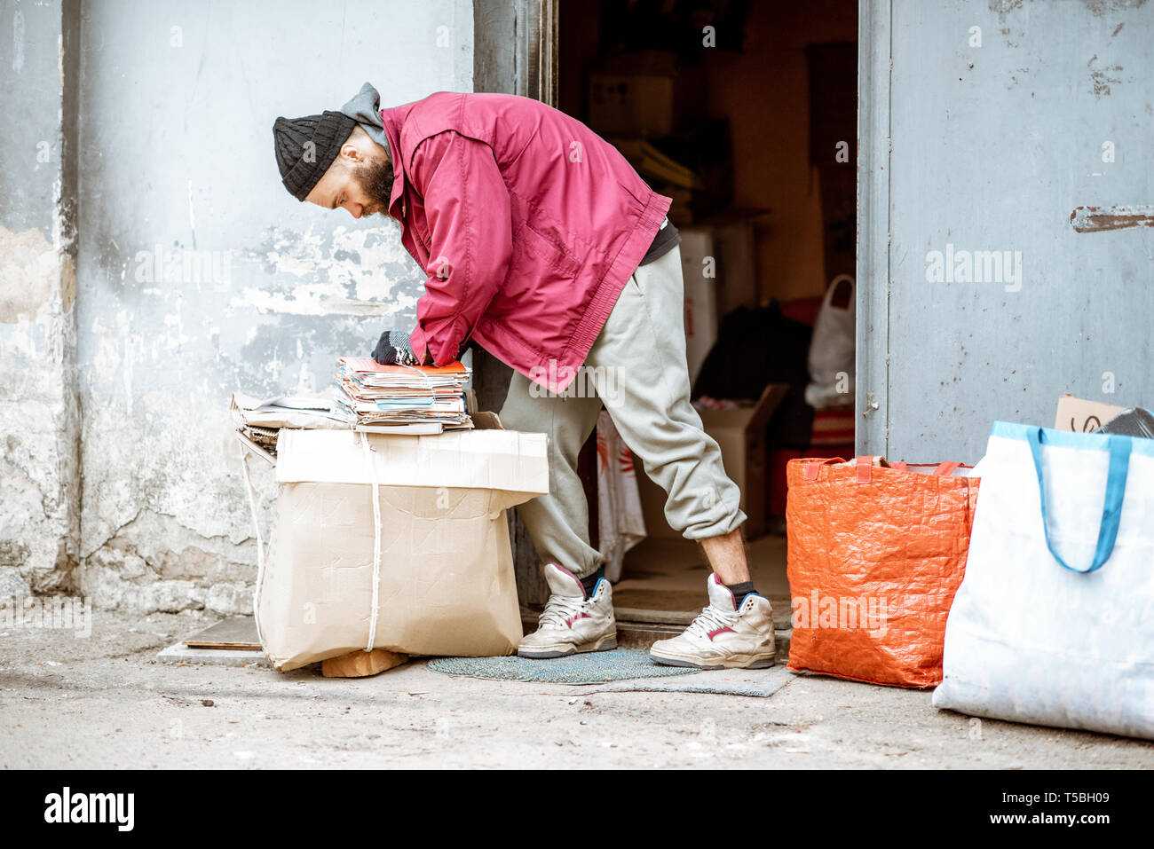 Homeless person collecting waste to recycle hi-res stock photography ...