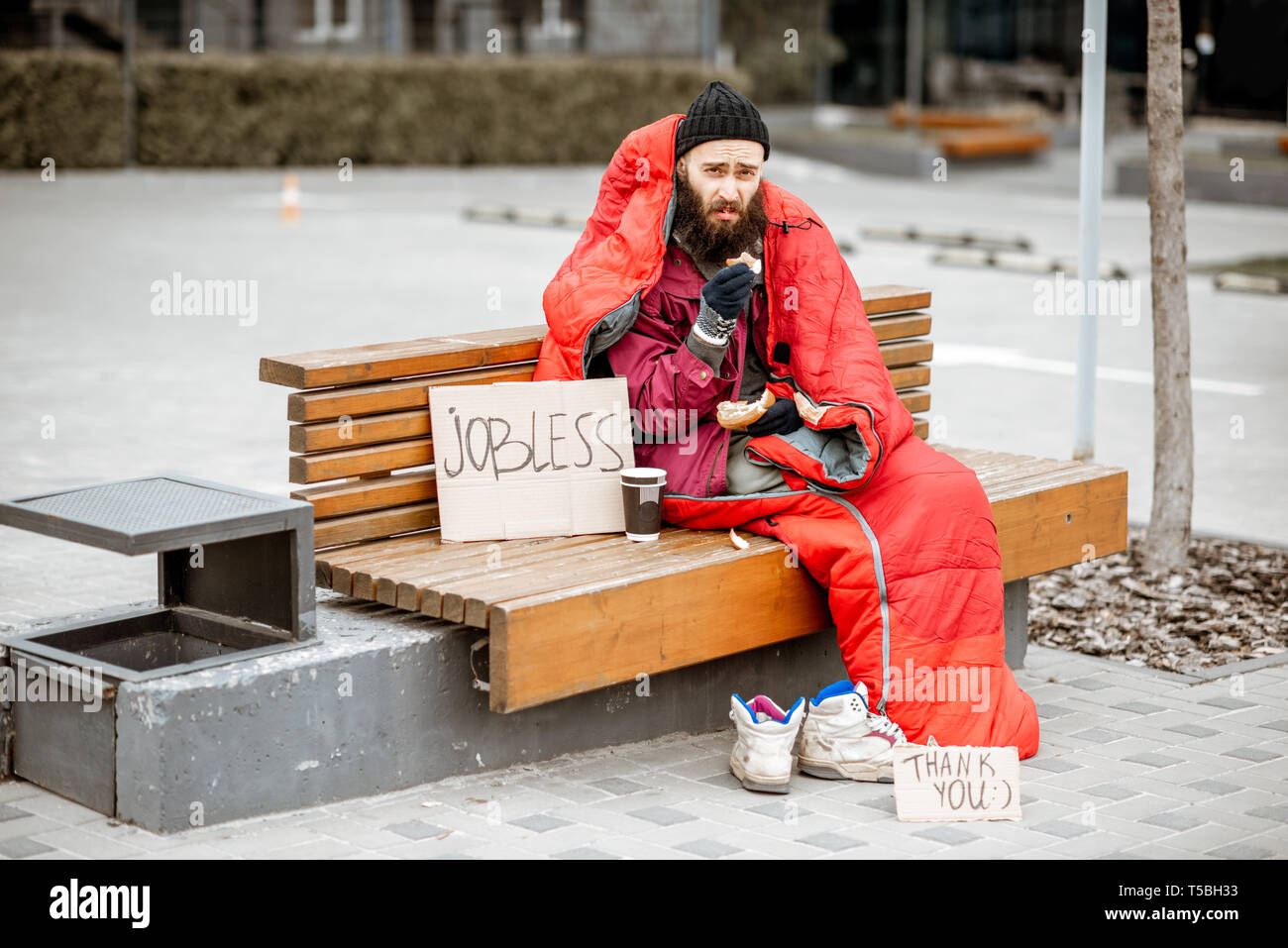 Homeless man eating food hi-res stock photography and images - Alamy