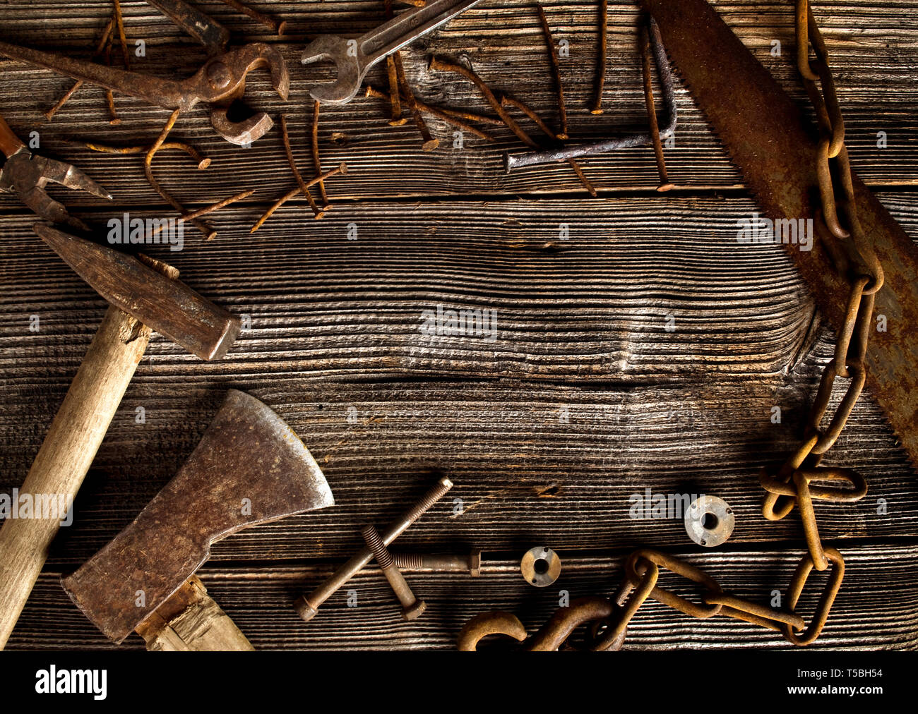 Rusty tools on old dark plank background with copyspace Stock Photo - Alamy