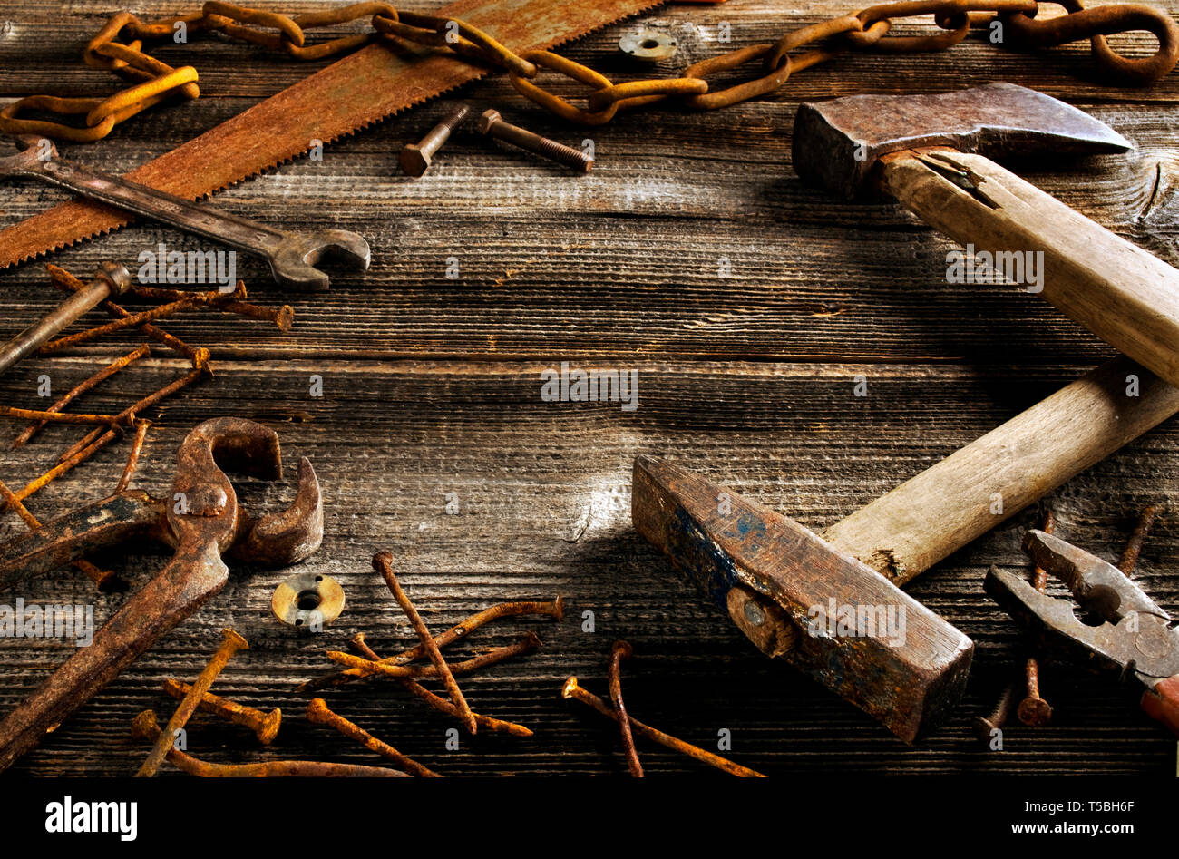 Rusty tools on old dark plank background with copyspace Stock Photo - Alamy