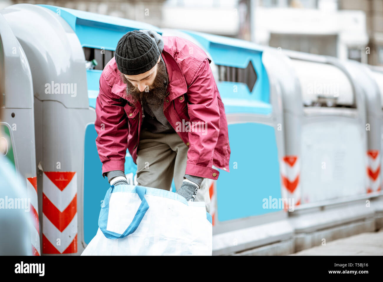 Homeless man searching in garbage hi-res stock photography and images ...