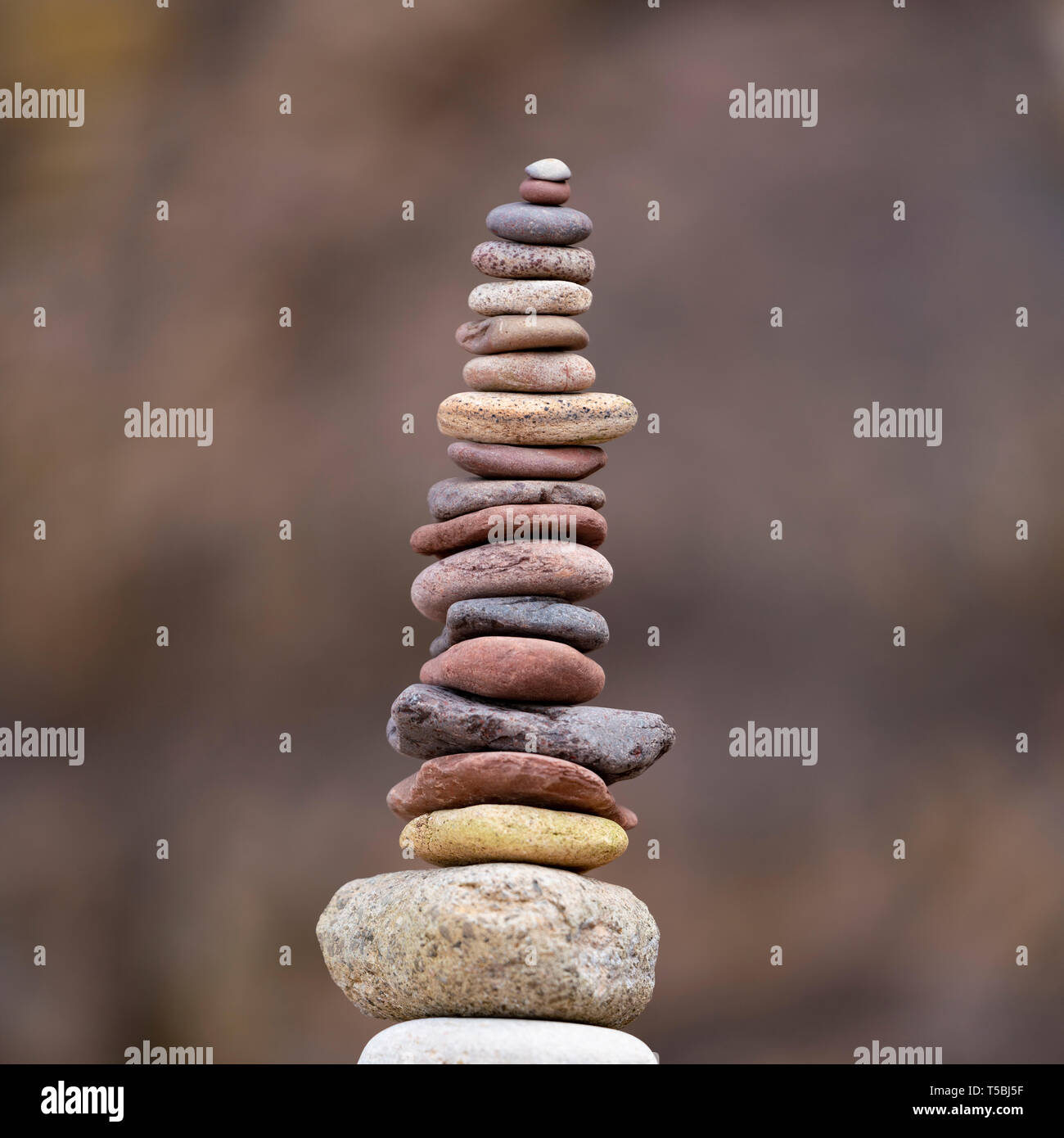 Stack of stones supported on rock Stock Photo - Alamy